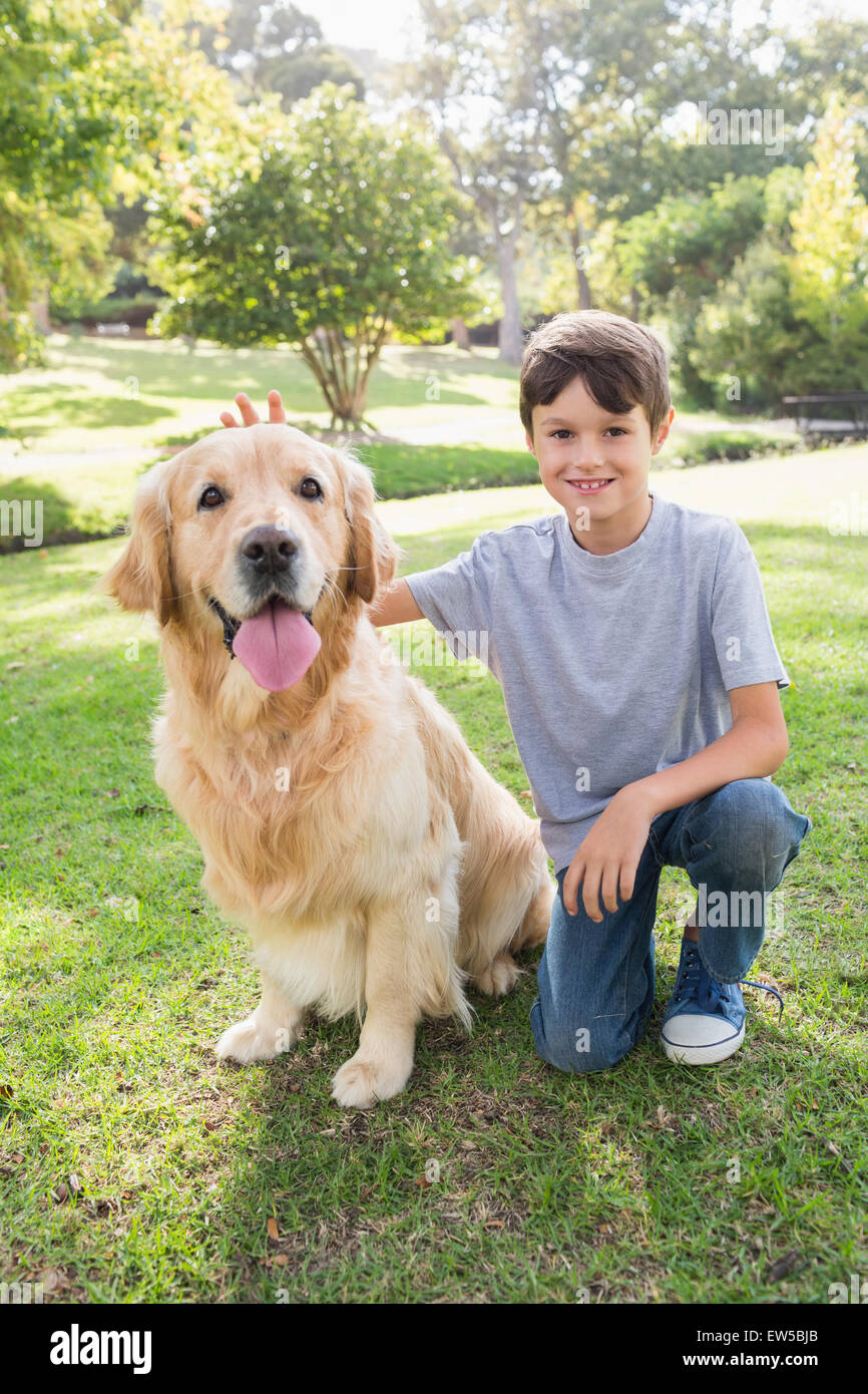Little boy with his dog in the park Stock Photo - Alamy
