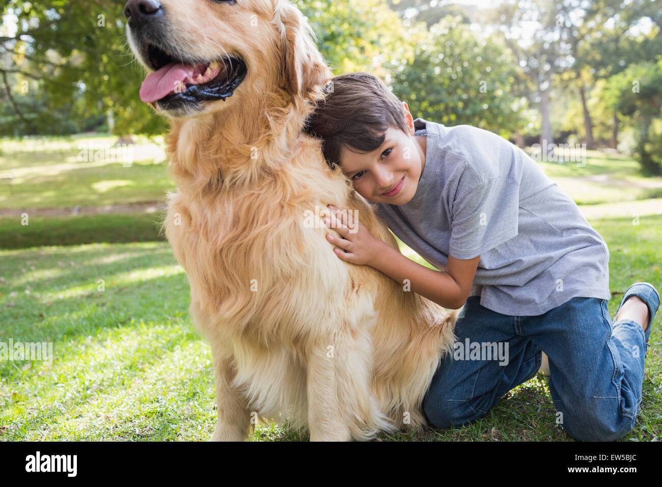Little boy with his dog in the park Stock Photo - Alamy