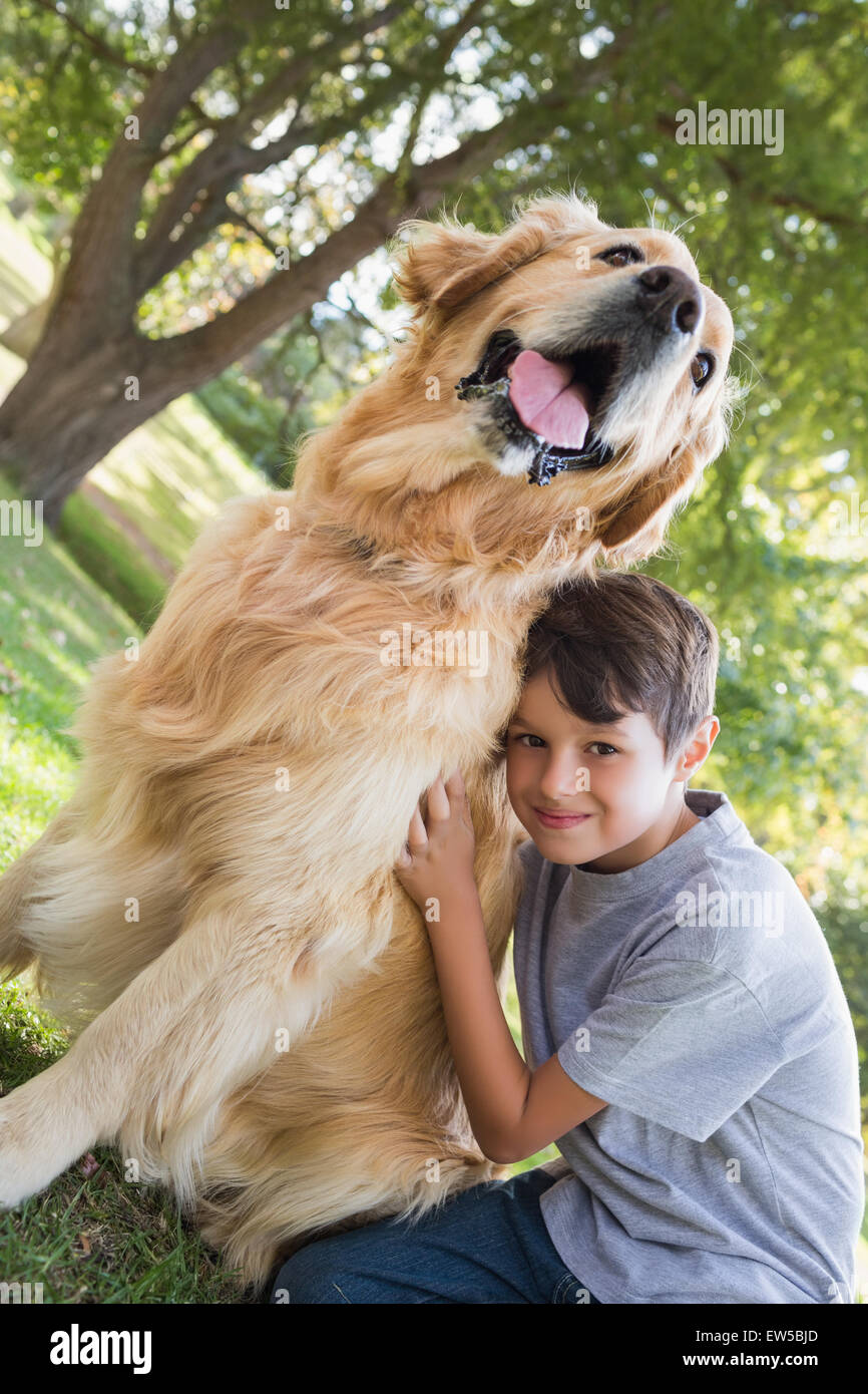 Little boy with his dog in the park Stock Photo - Alamy