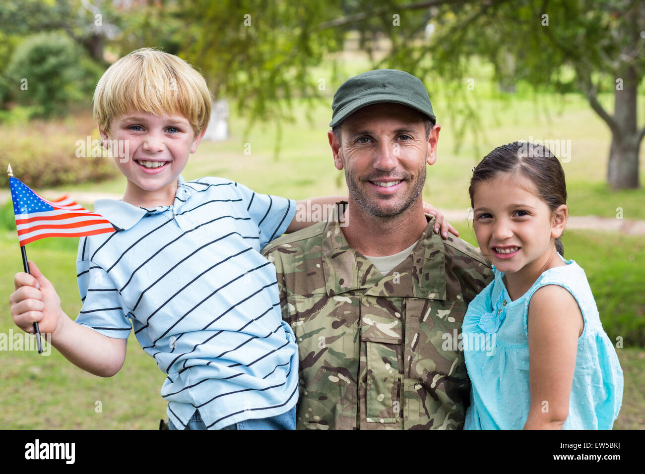 Handsome soldier reunited with family Stock Photo - Alamy