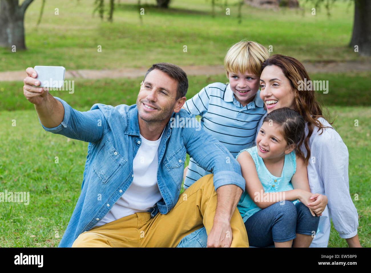 Happy family in the park together Stock Photo - Alamy