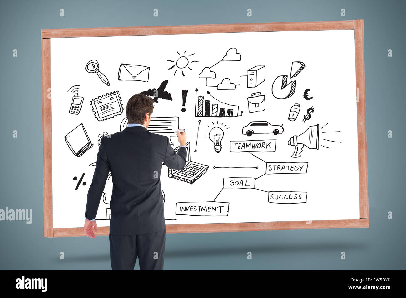 Composite image of businessman standing back to camera writing with ...