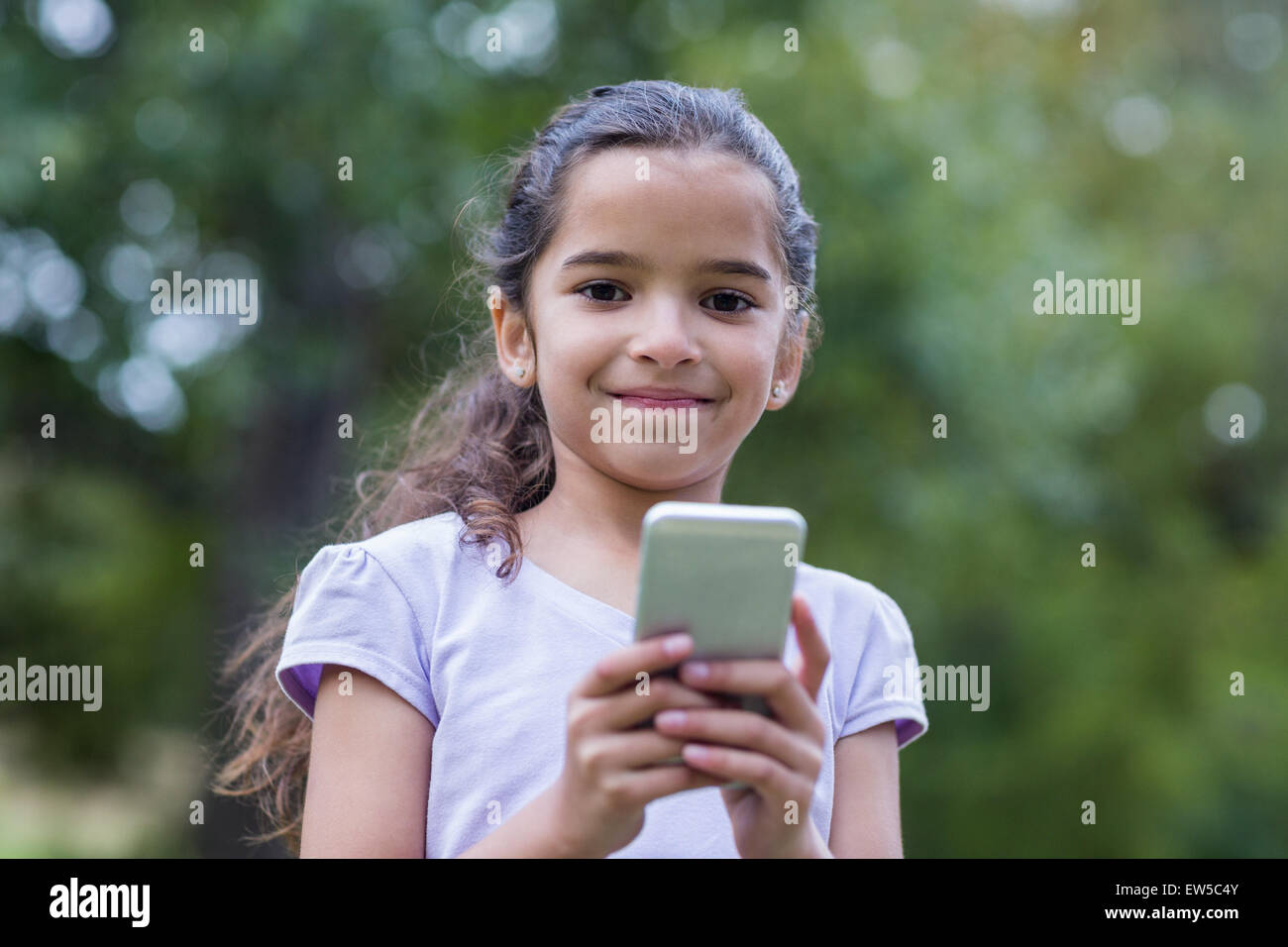 Little girl using her phone Stock Photo - Alamy