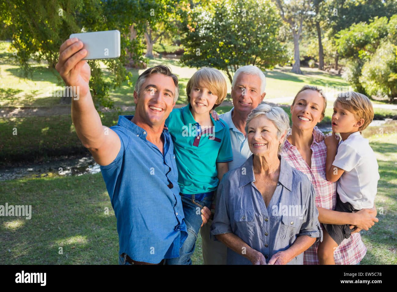 Happy family taking a selfie in the park Stock Photo - Alamy