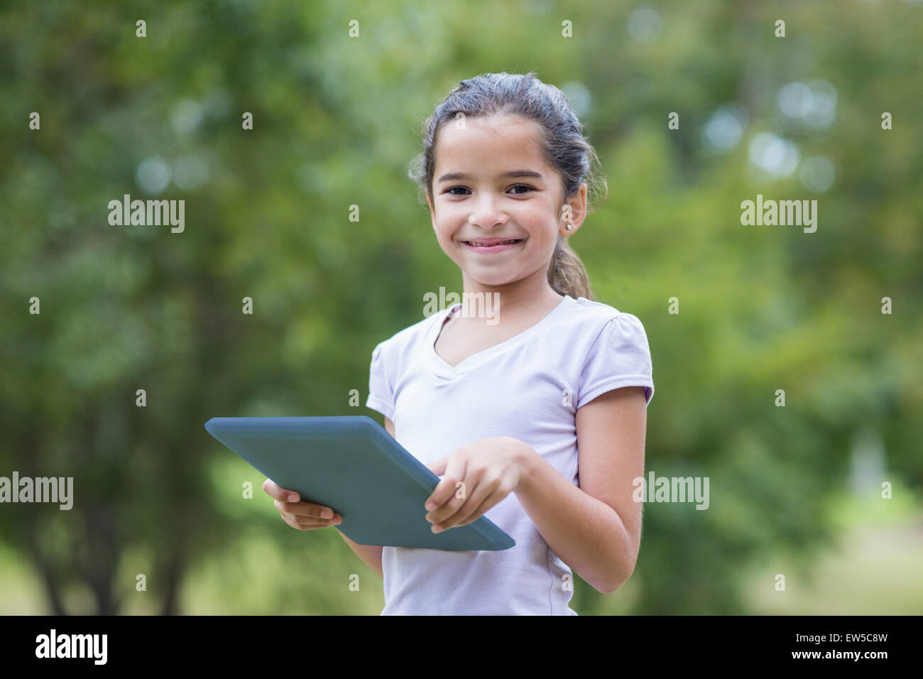Little girl using her tablet Stock Photo - Alamy