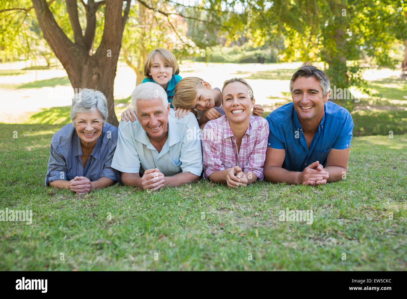 Happy family smiling at the camera Stock Photo - Alamy