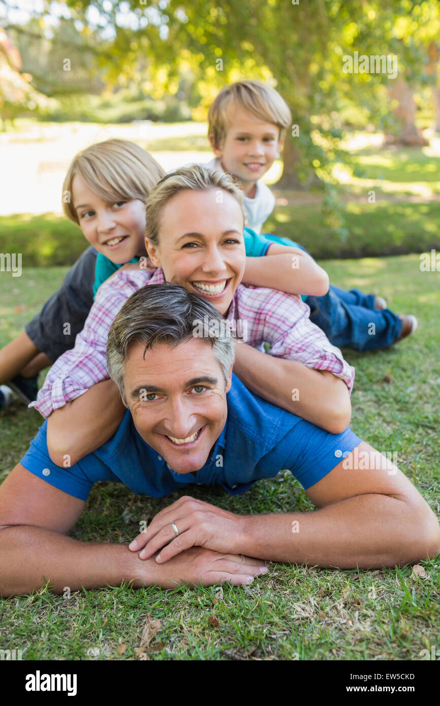 Happy family smiling at the camera Stock Photo - Alamy