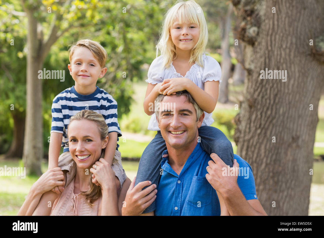 Happy family playing in the park together Stock Photo - Alamy