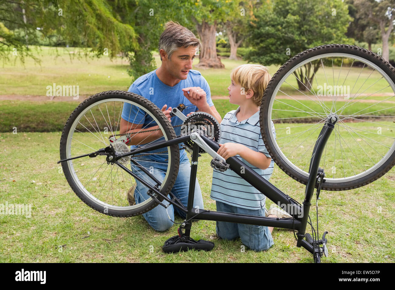 Father and his son fixing a bike Stock Photo - Alamy