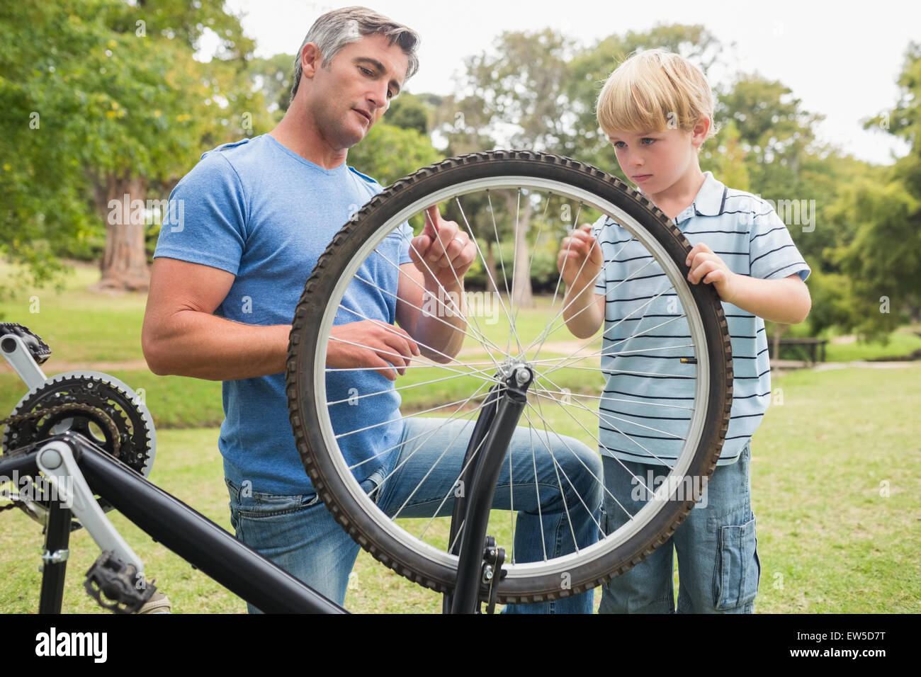 Father and his son fixing a bike Stock Photo - Alamy
