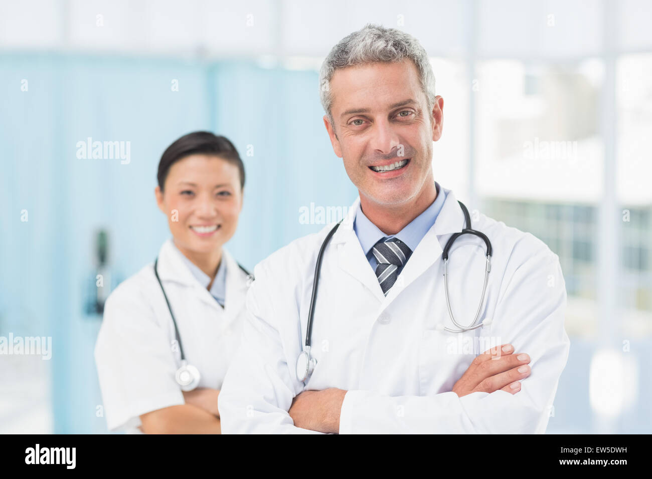 Confident male and female doctors Stock Photo - Alamy