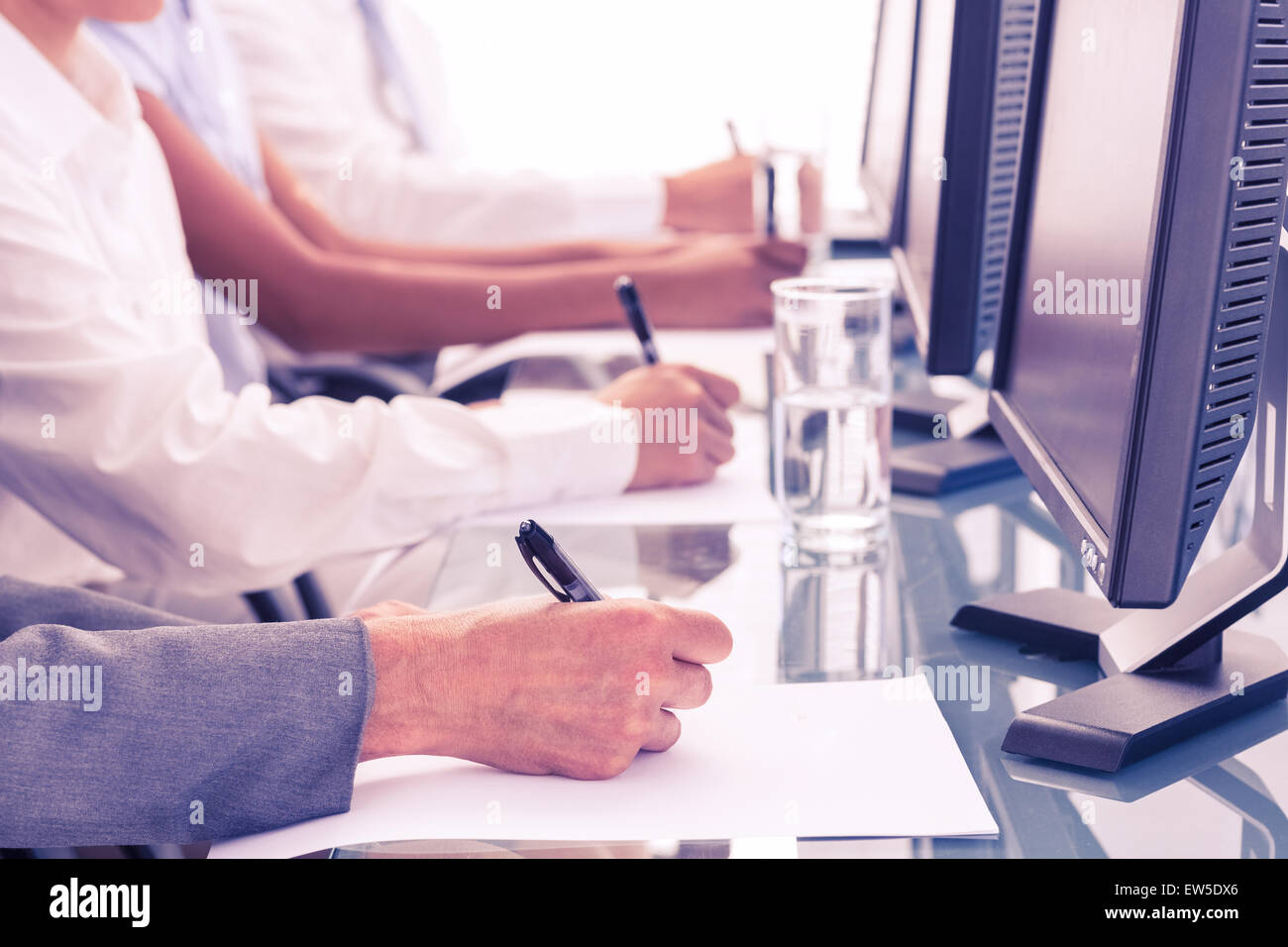 Close up view of business people writing on paper Stock Photo - Alamy