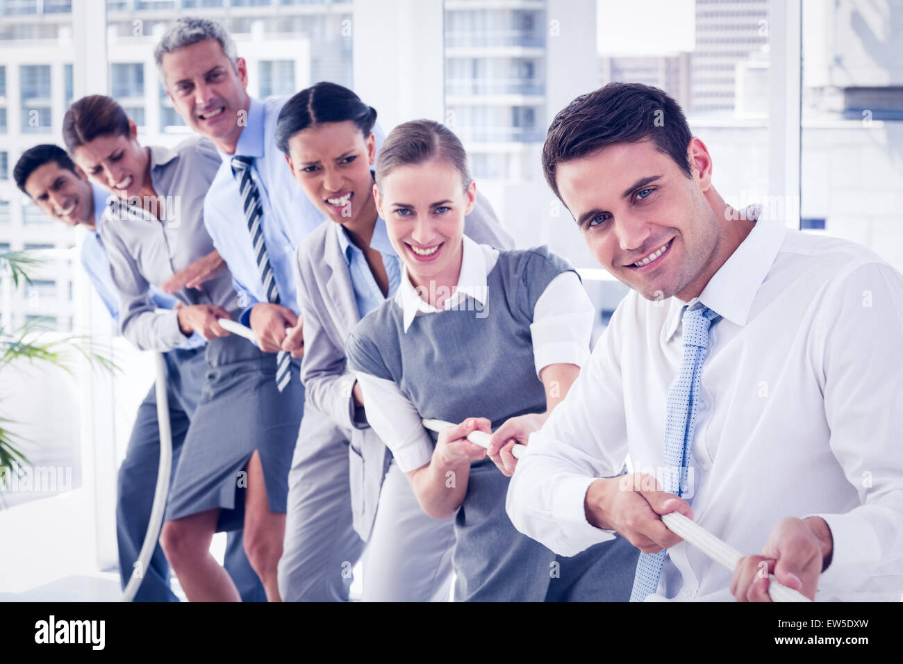 Business people pulling rope Stock Photo - Alamy