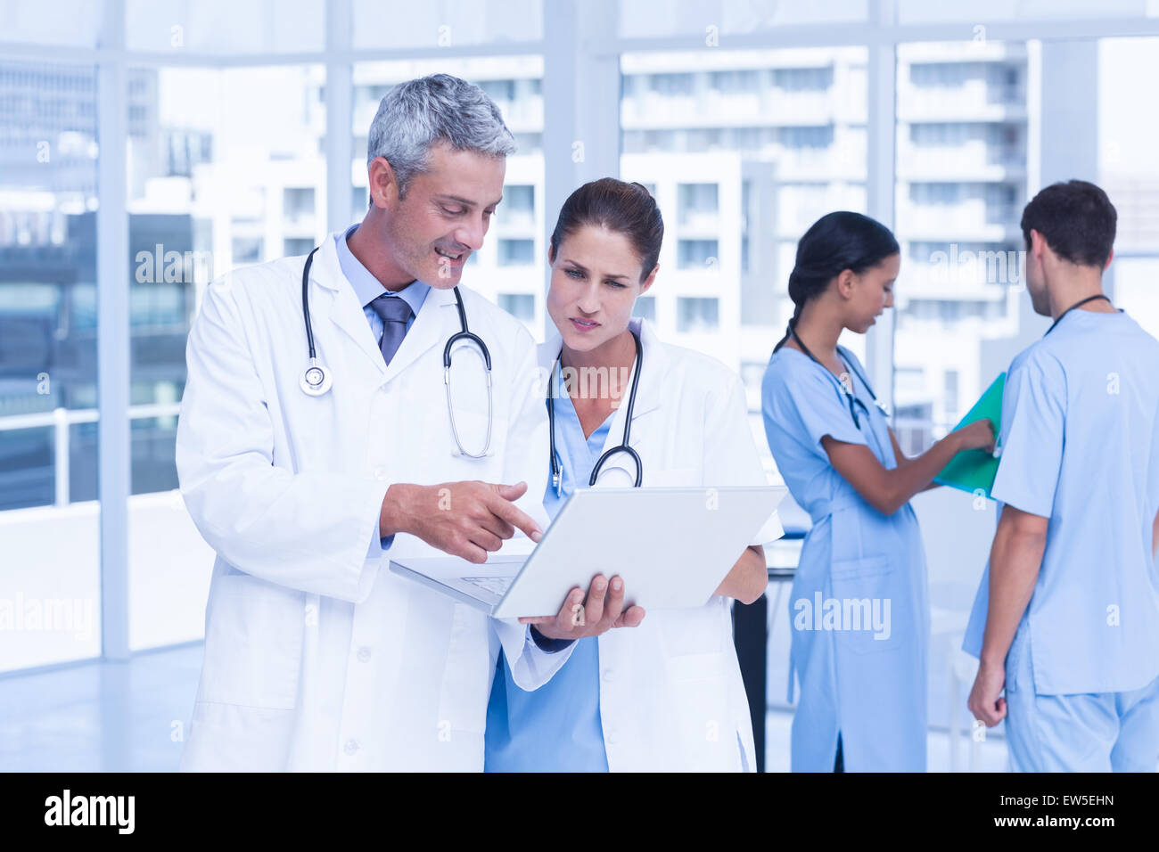 Male and female doctors working on reports Stock Photo - Alamy