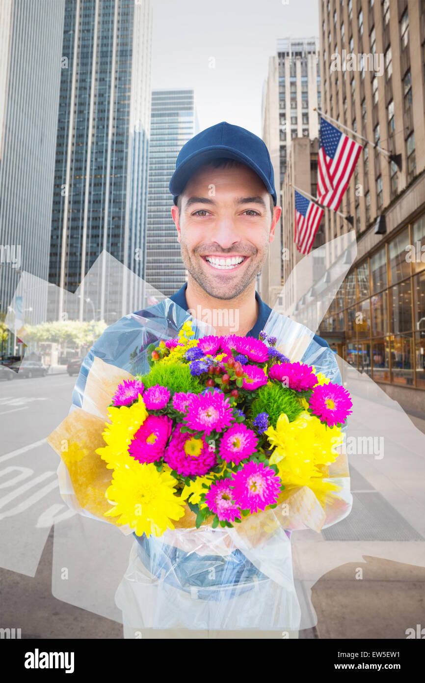 Composite image of happy delivery man holding bouquet Stock Photo - Alamy