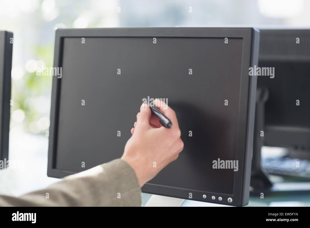 Businesswoman touching computer screen with pen Stock Photo - Alamy