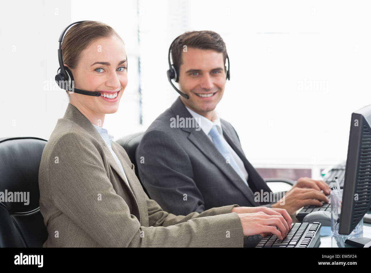Business people headsets using computers hi-res stock photography and ...