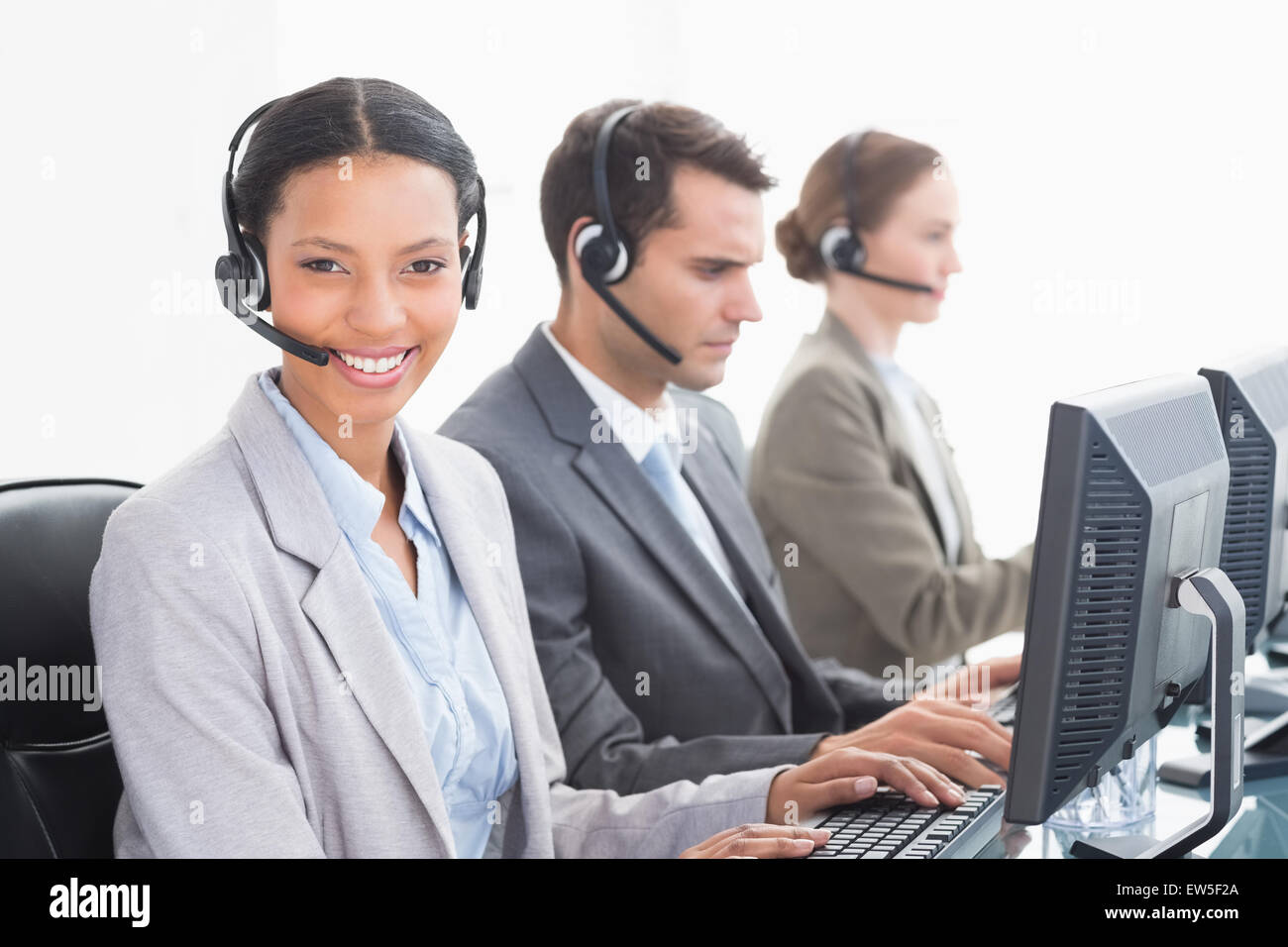 Business people with headsets using computers Stock Photo - Alamy