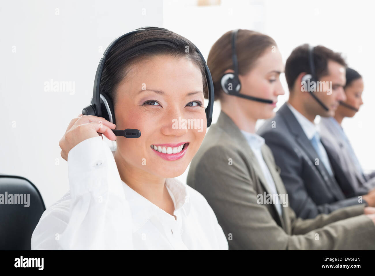 Business people with headsets using computers Stock Photo - Alamy