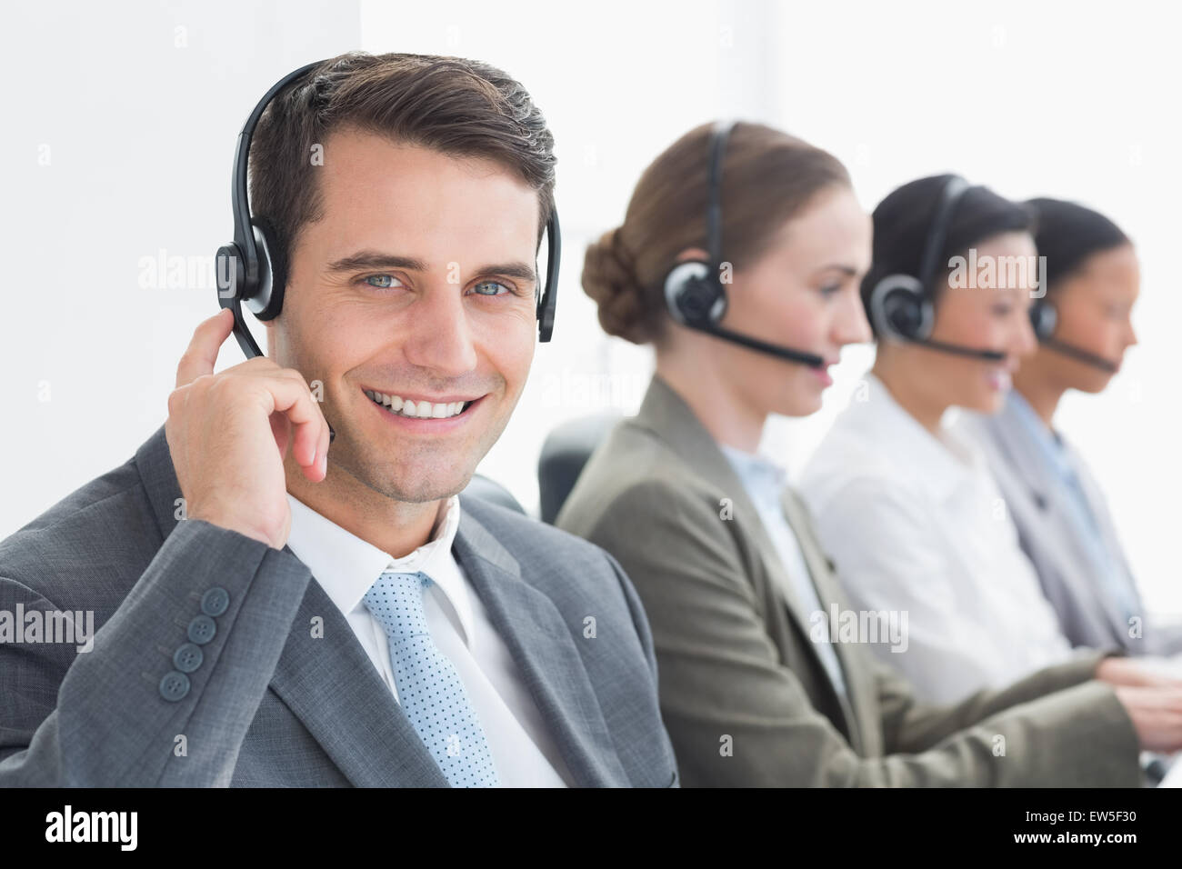 Business people with headsets using computers Stock Photo - Alamy