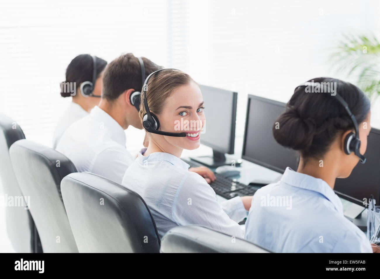 Business people with headsets using computers Stock Photo - Alamy