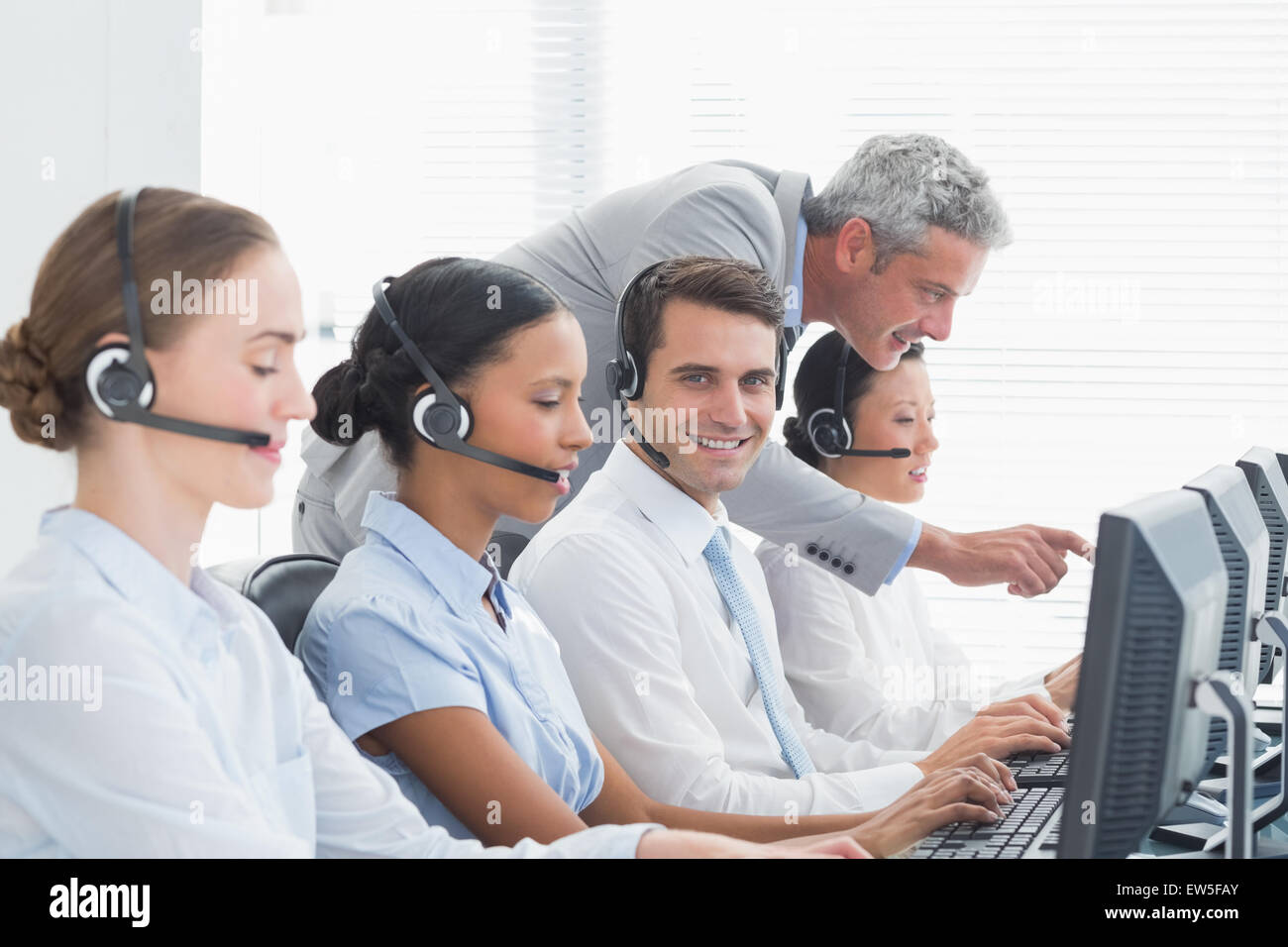 Manager checking his colleagues works Stock Photo - Alamy