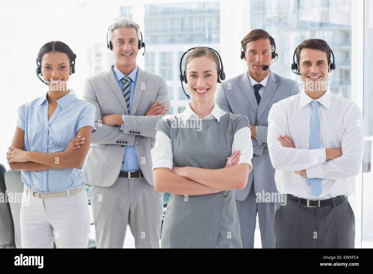 Business people with headsets smiling at camera Stock Photo - Alamy