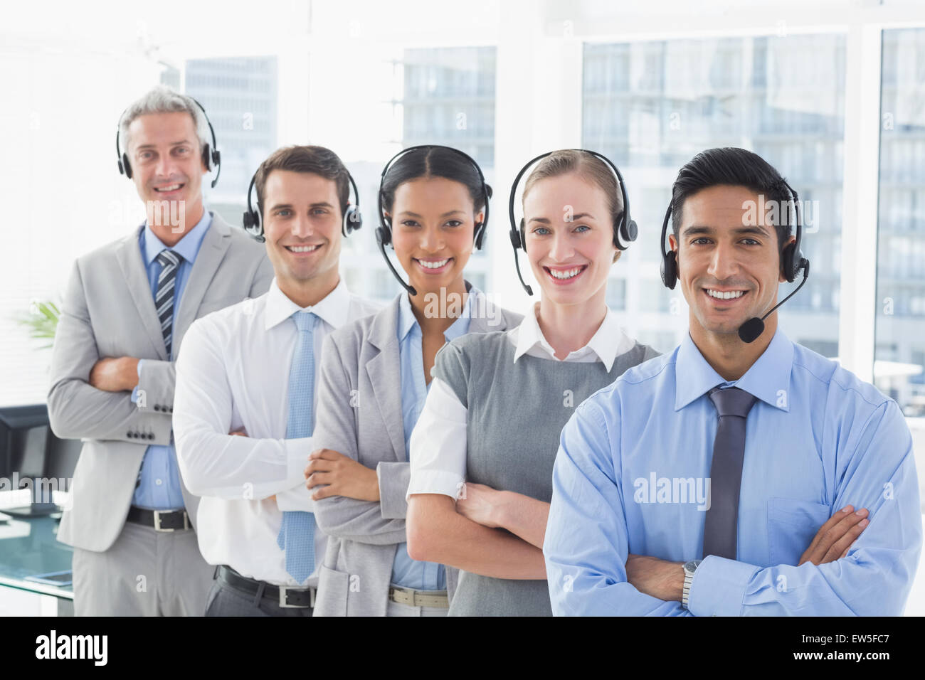 Business people with headsets smiling at camera Stock Photo - Alamy