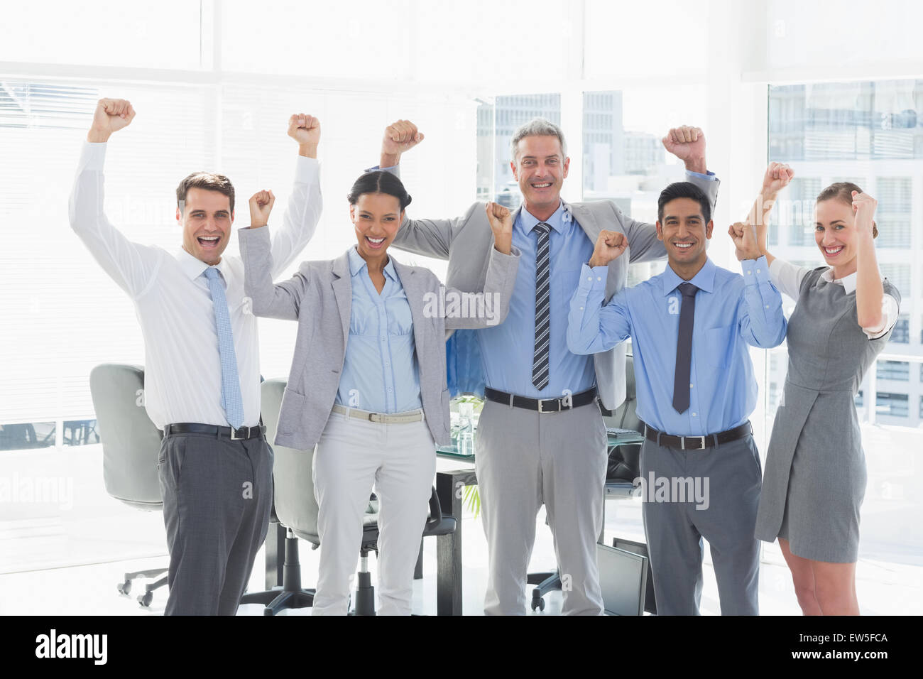 Business people cheering in office Stock Photo - Alamy