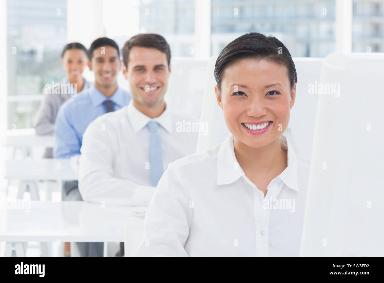 Smiling work team using computer Stock Photo - Alamy