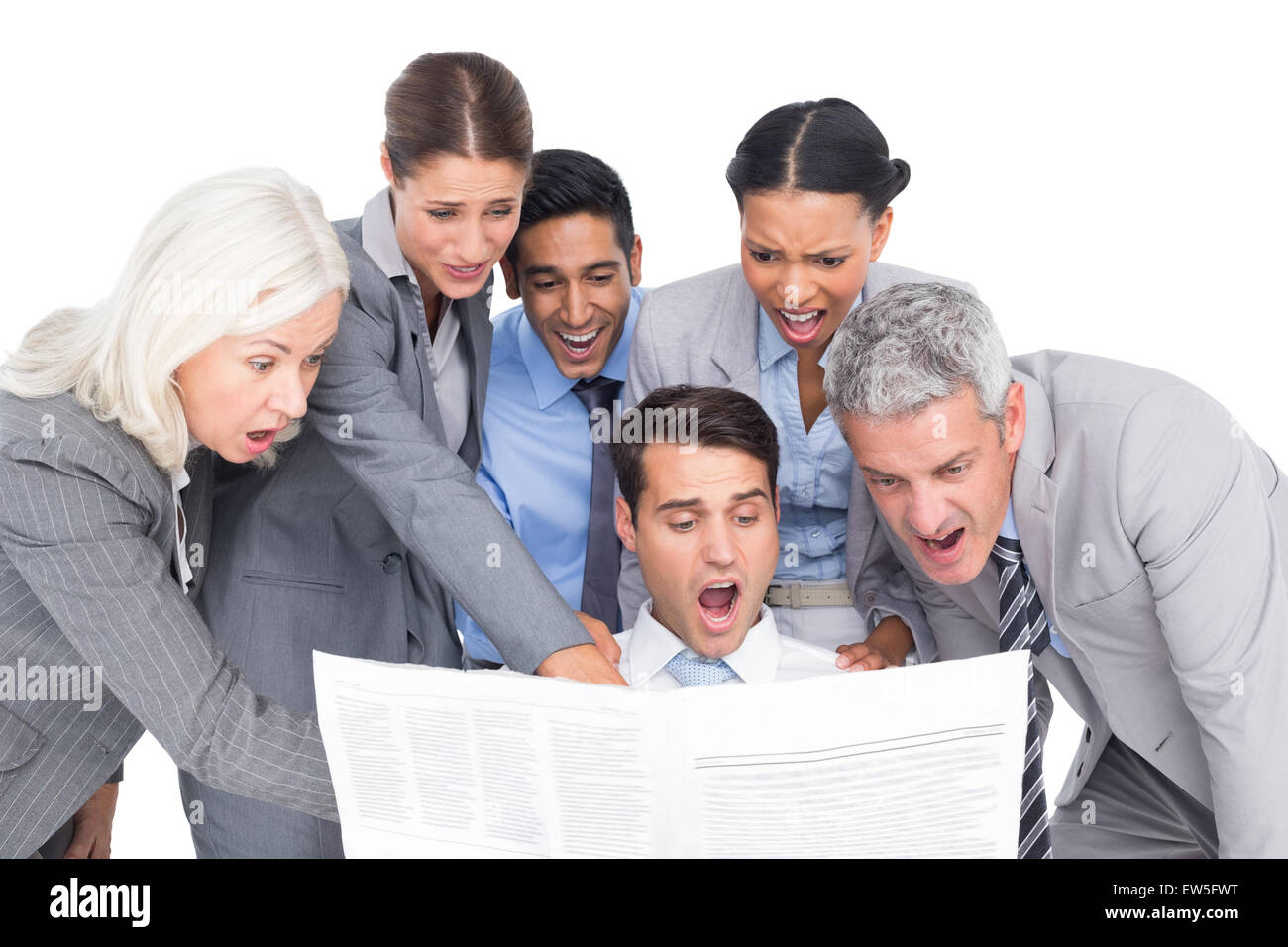 Surprising business people looking at newspaper Stock Photo - Alamy