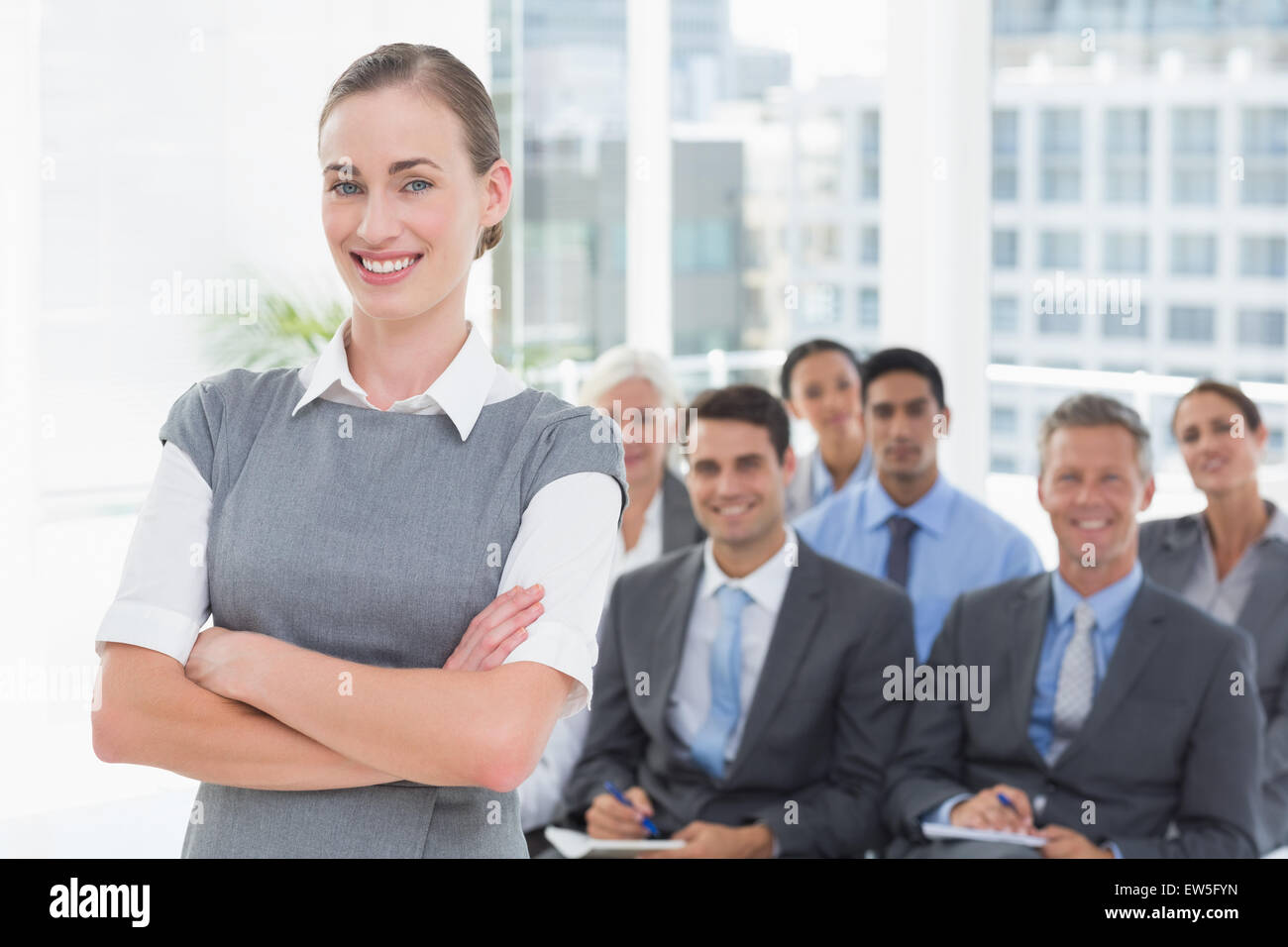 Business people looking at camera with arms crossed Stock Photo - Alamy