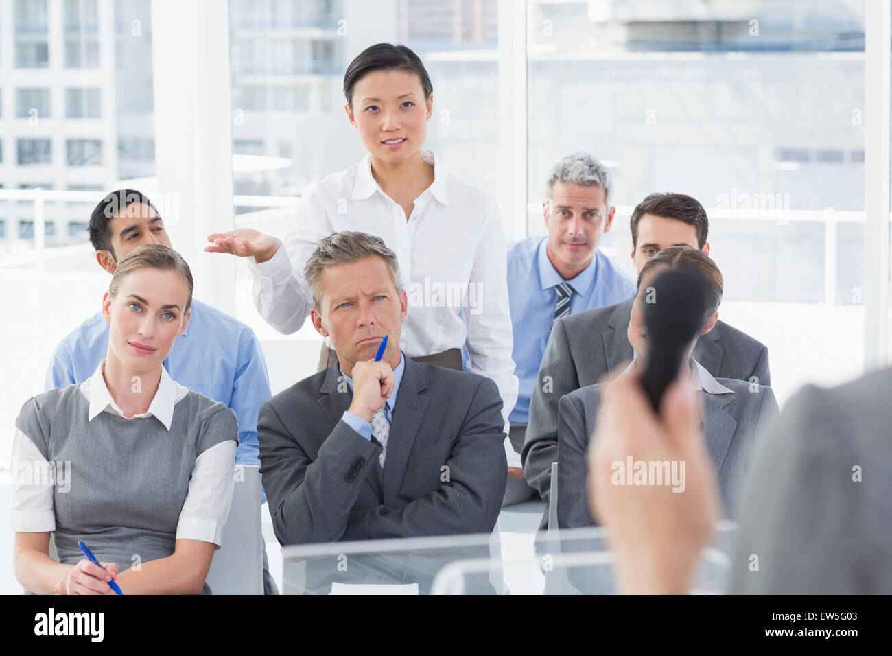 Businesswoman asking question during meeting Stock Photo - Alamy