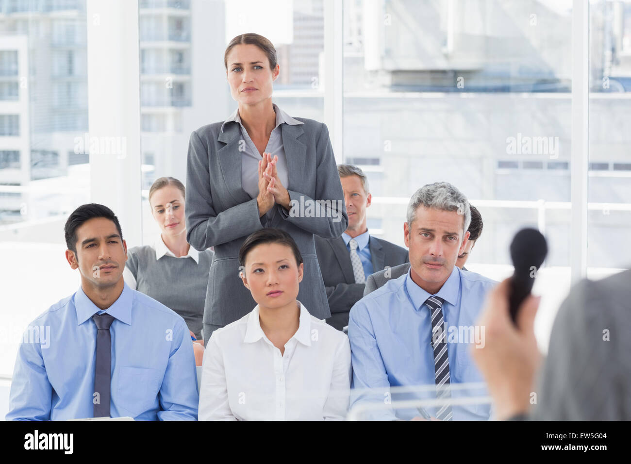Businesswoman asking question during meeting Stock Photo - Alamy