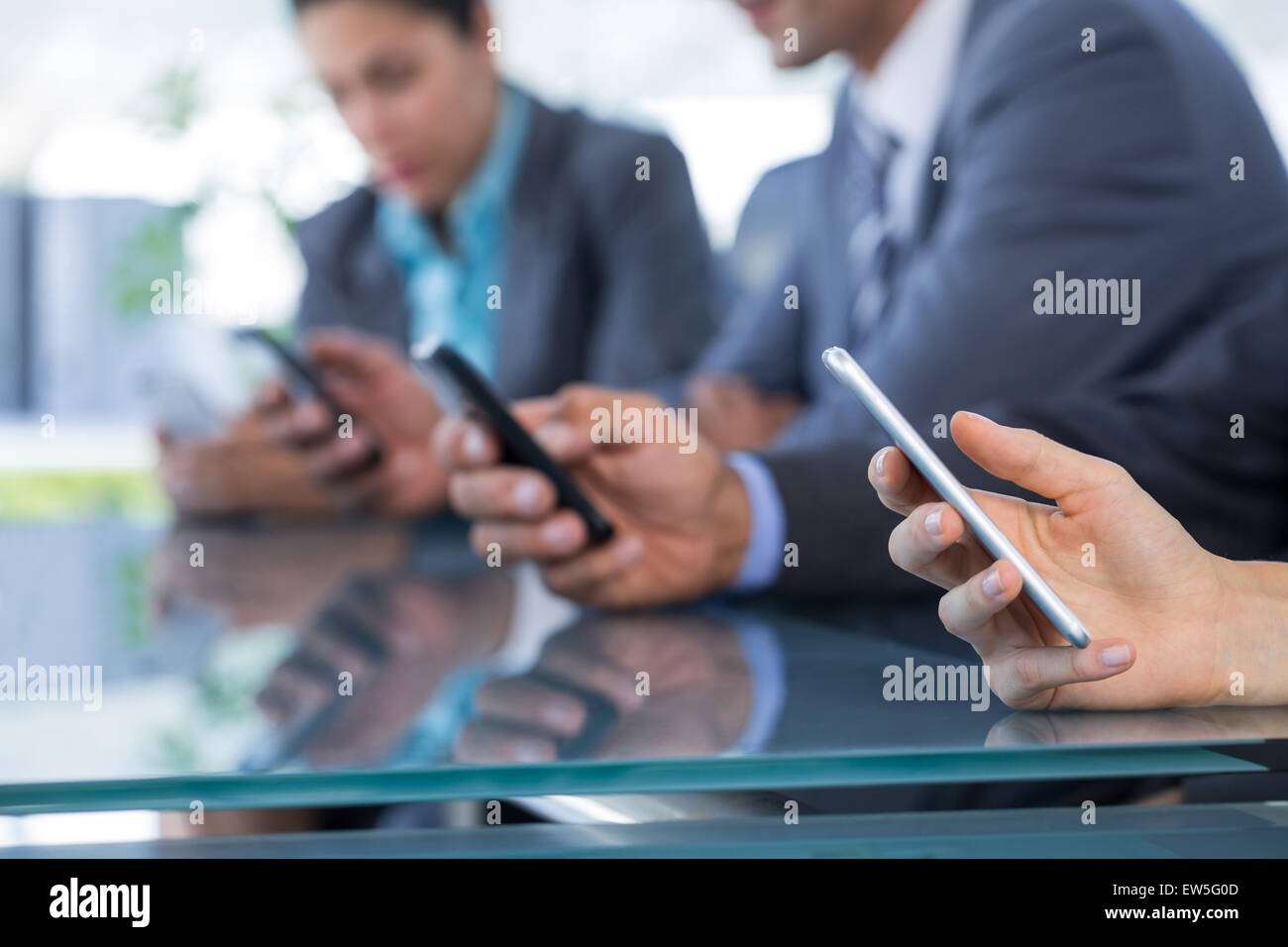 Business team using their mobile phone Stock Photo - Alamy