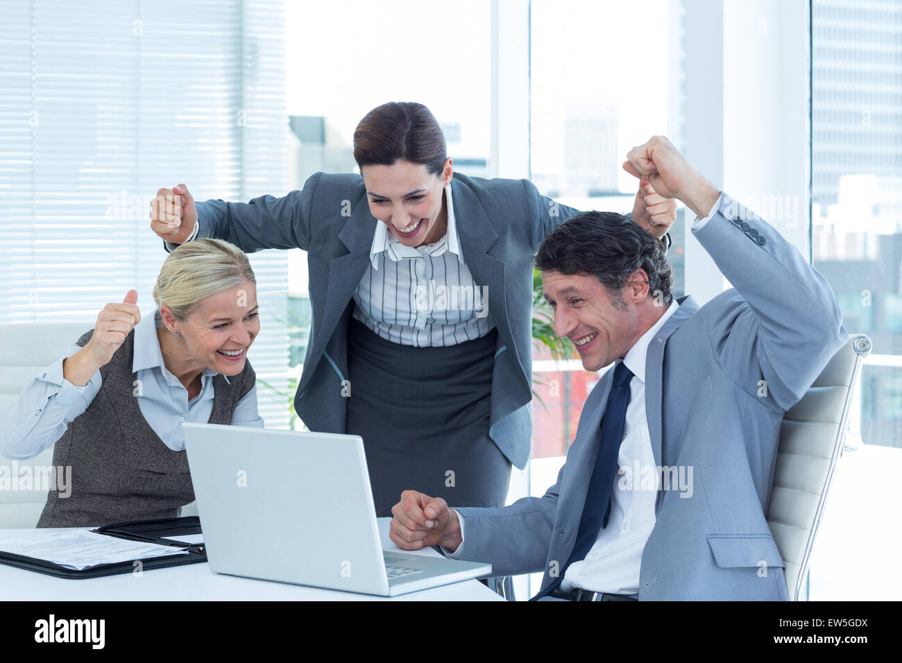 Mature woman laptop cheering hi-res stock photography and images - Alamy