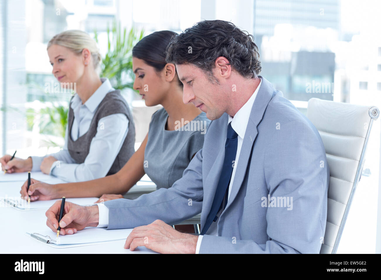 Group of business people taking notes Stock Photo - Alamy