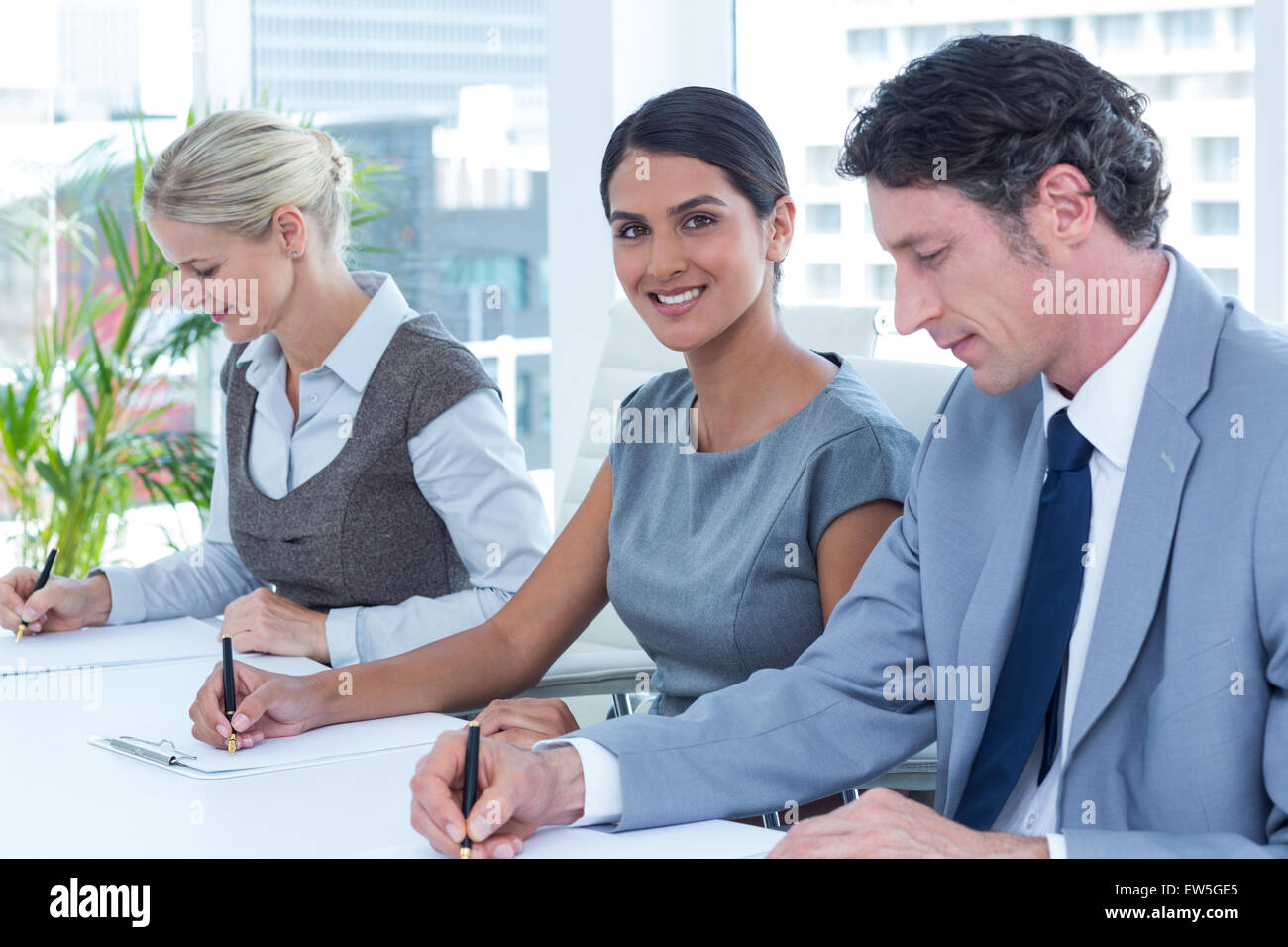 Group of business people taking notes Stock Photo - Alamy