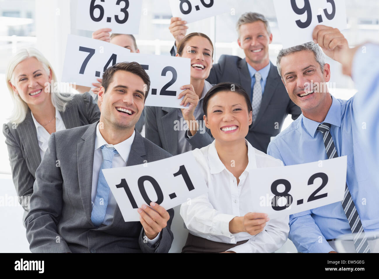 Interview panel holding score cards in office Stock Photo - Alamy