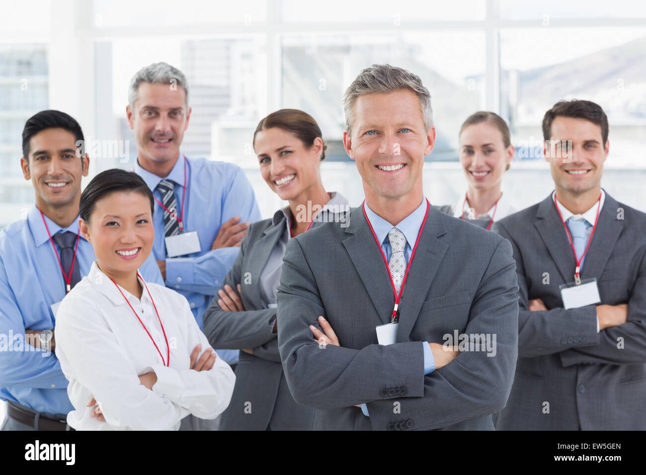 Business people looking at camera with arms crossed Stock Photo - Alamy