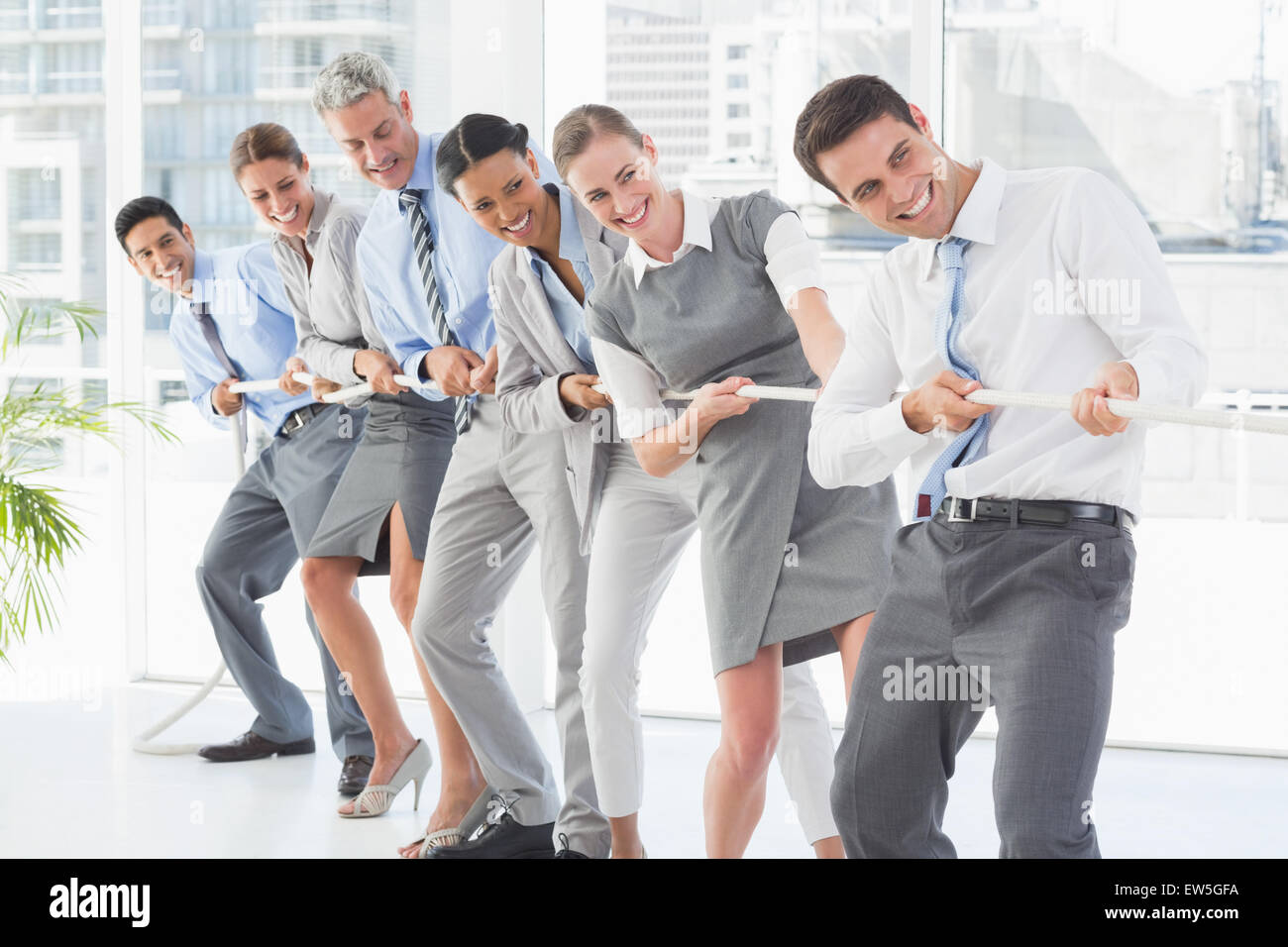 Business people pulling rope Stock Photo - Alamy