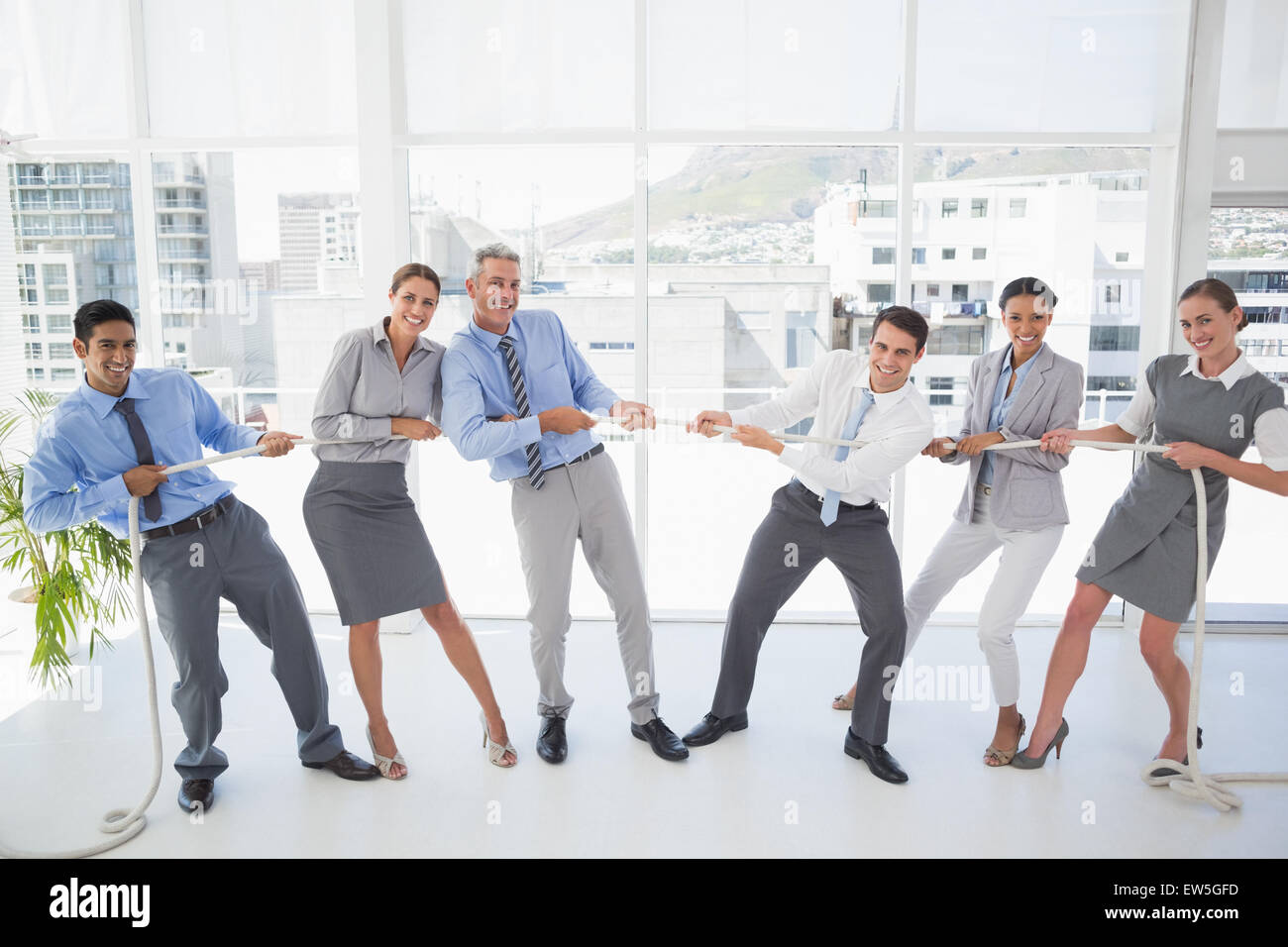 Business people pulling rope Stock Photo - Alamy