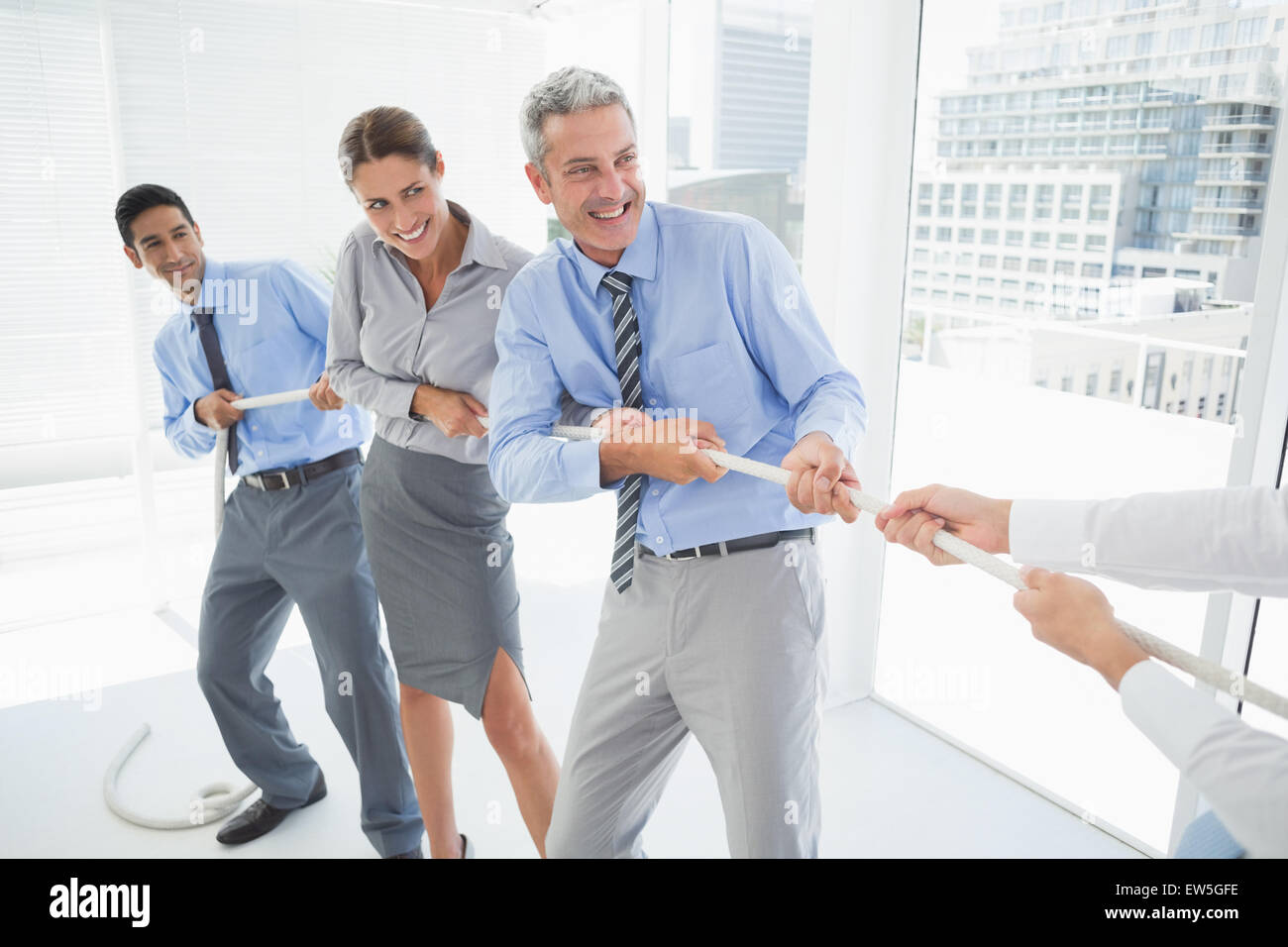 Business people pulling rope Stock Photo - Alamy