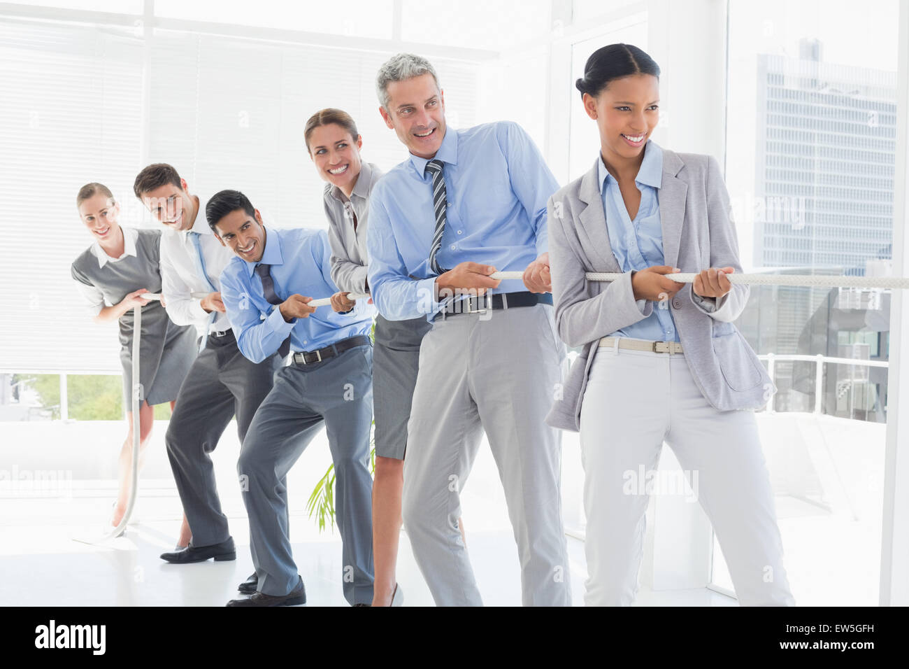 Business people pulling rope Stock Photo - Alamy