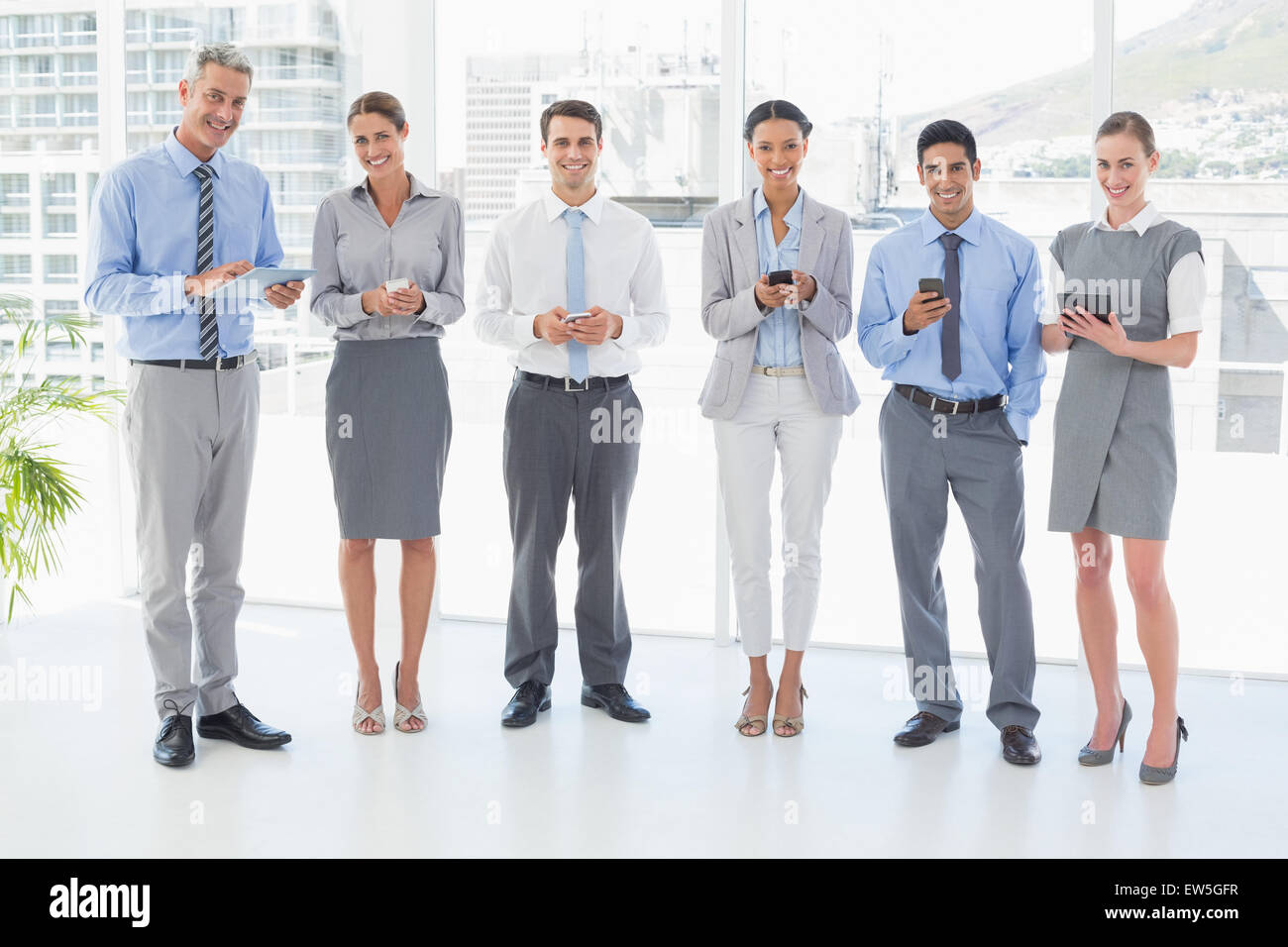 Business people using their phone Stock Photo - Alamy