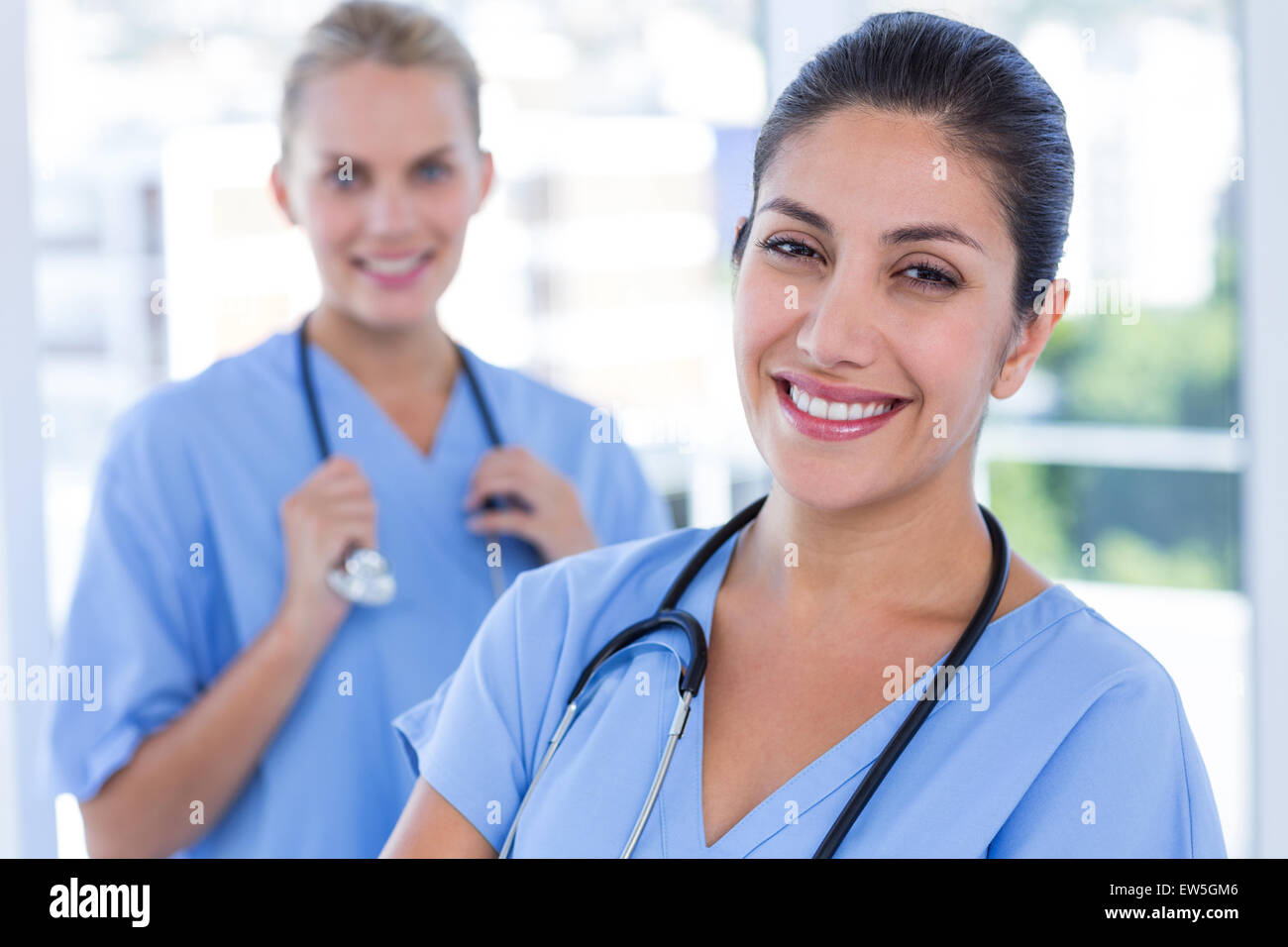 Happy doctors looking at camera Stock Photo - Alamy