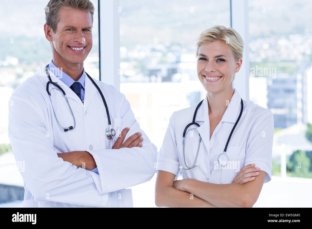 Smiling doctors looking at camera Stock Photo - Alamy