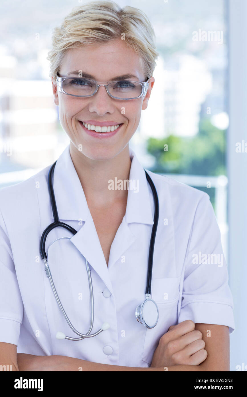 Happy female doctor looking at camera with arms crossed Stock Photo - Alamy