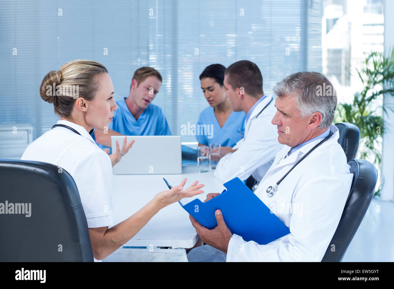 Team of doctors working on their files Stock Photo - Alamy