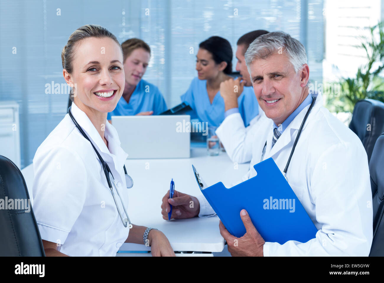 Team of doctors working on their files Stock Photo - Alamy